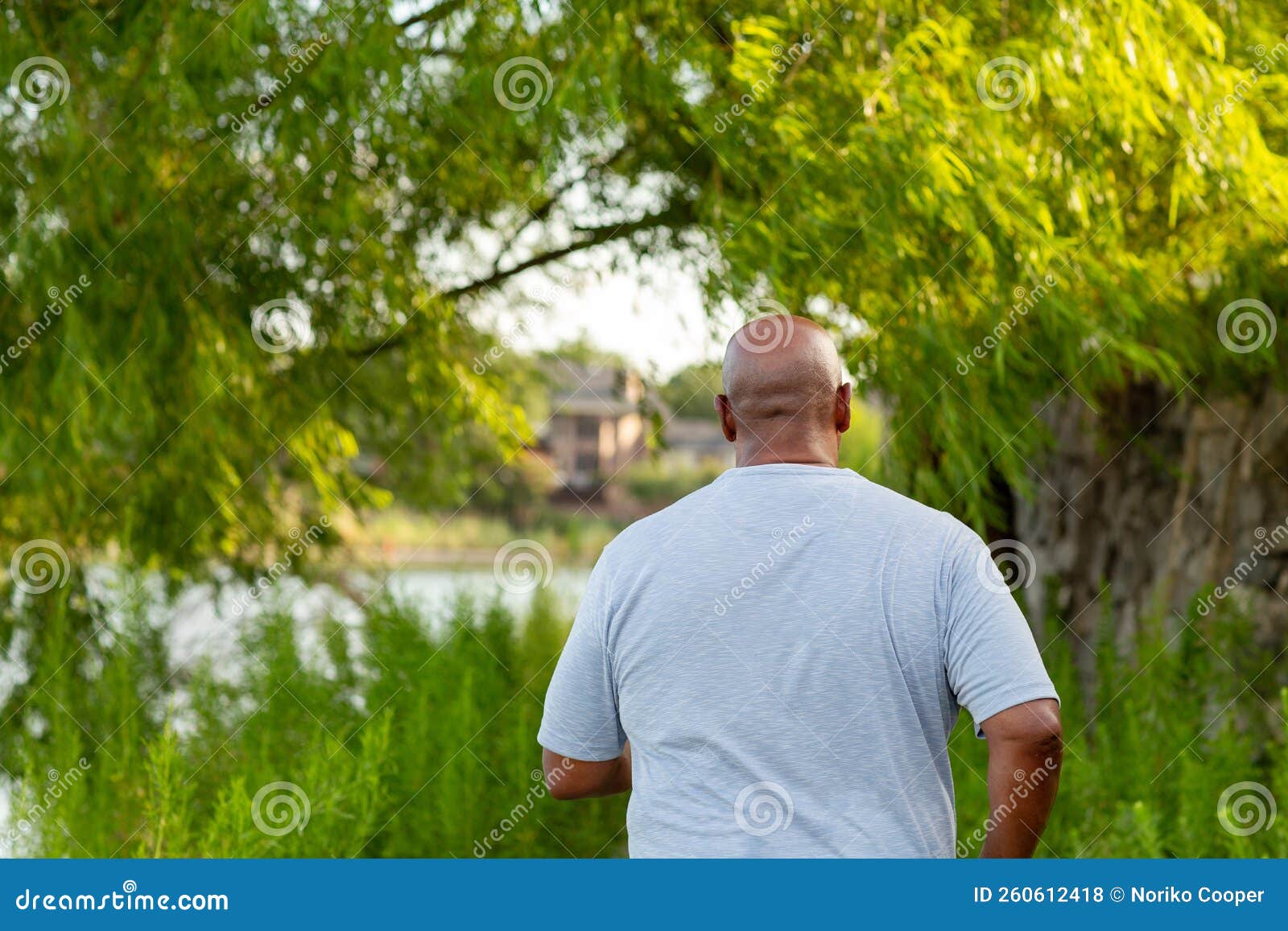 Rear View of a Mature Man Walking and Getting Exercise Stock Photo ...