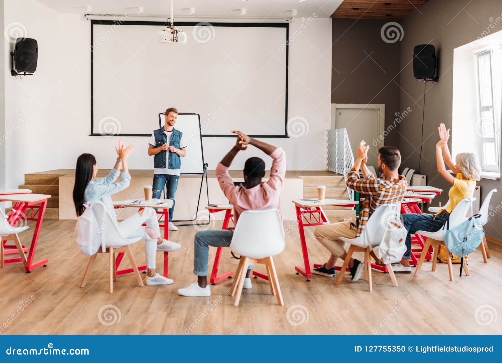 Rear View of Multiethnic Young Students Clapping To Lecturer after ...