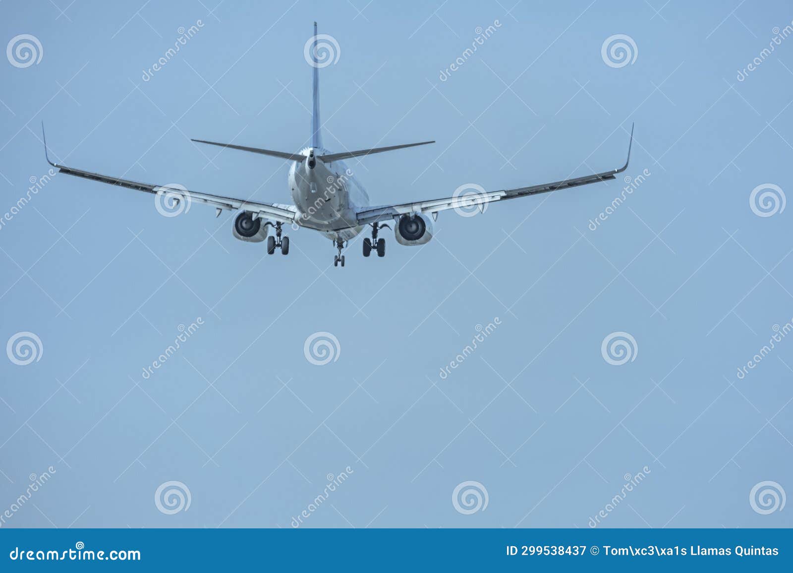 Rear View of a Passenger Jet with Landing Gear Deployed Approaching the ...