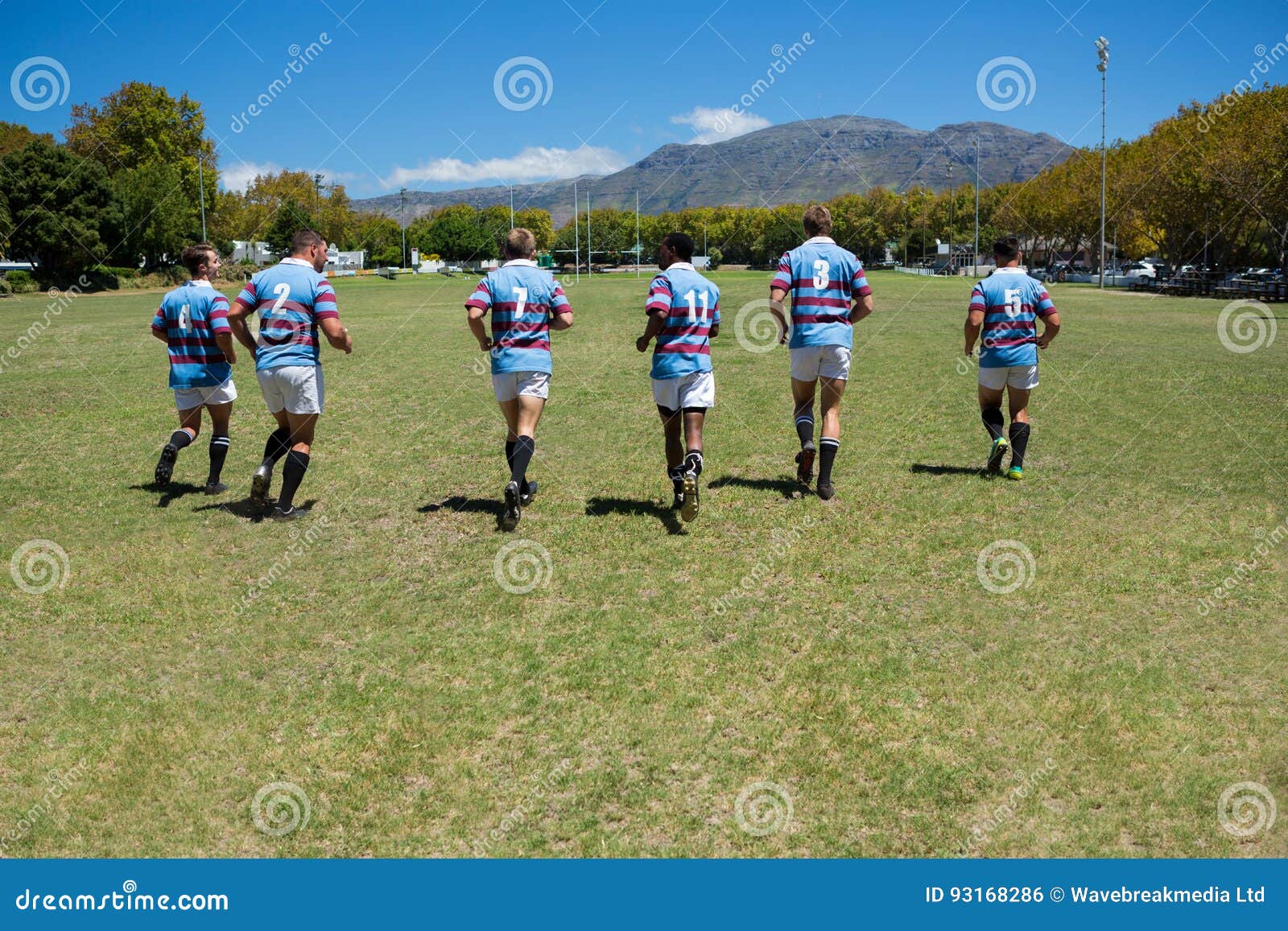 Rear View of Rugby Team Running at Field Stock Photo - Image of ...