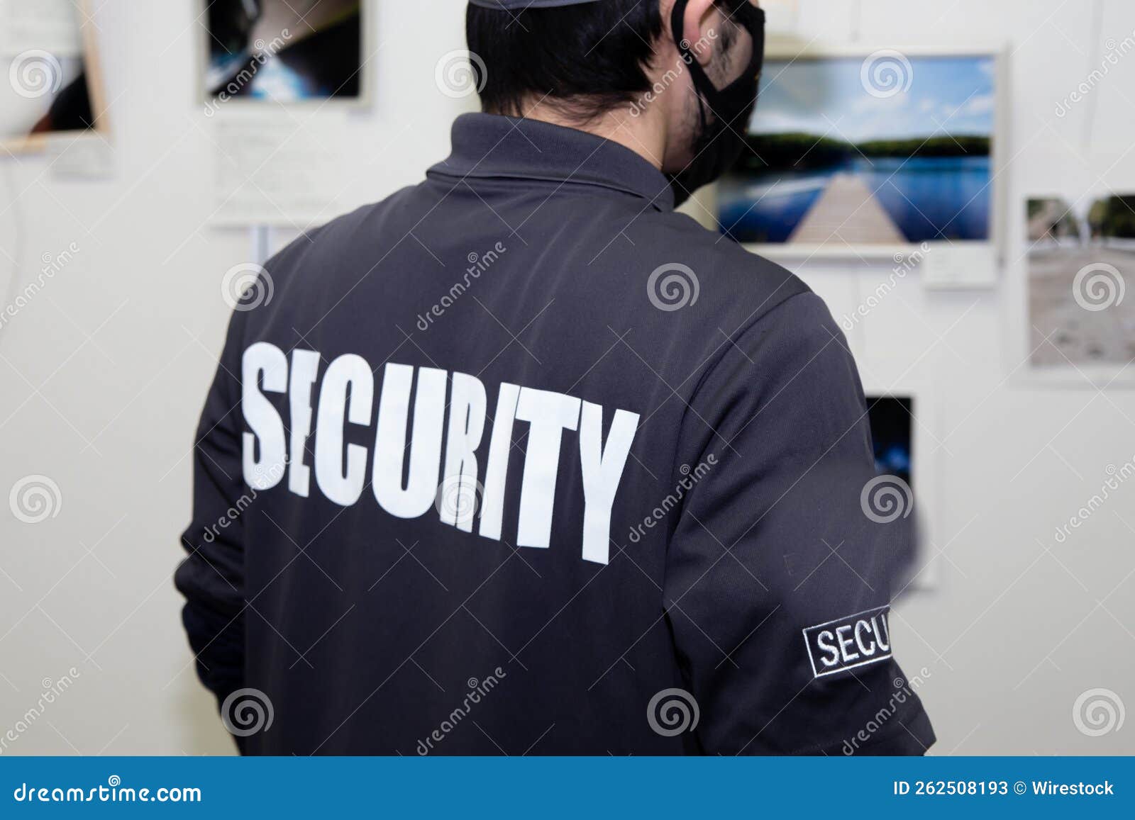 Rear View of a Security Guard in Uniform Patrolling in a Commercial ...