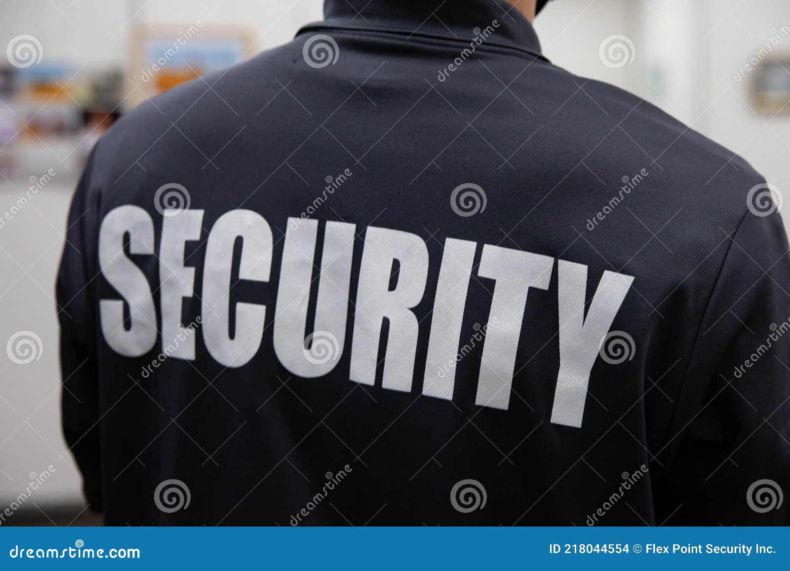 Rear View of Security Guard in Uniform Patrolling in Commercial Mall ...