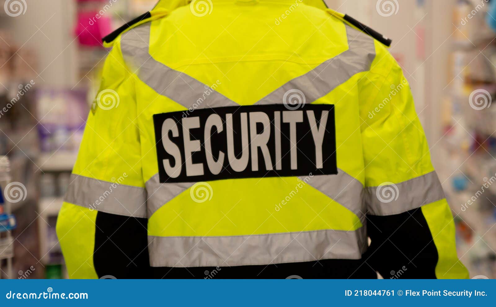 Rear View Of Security Guard In Uniform Patrolling In Commercial Mall ...