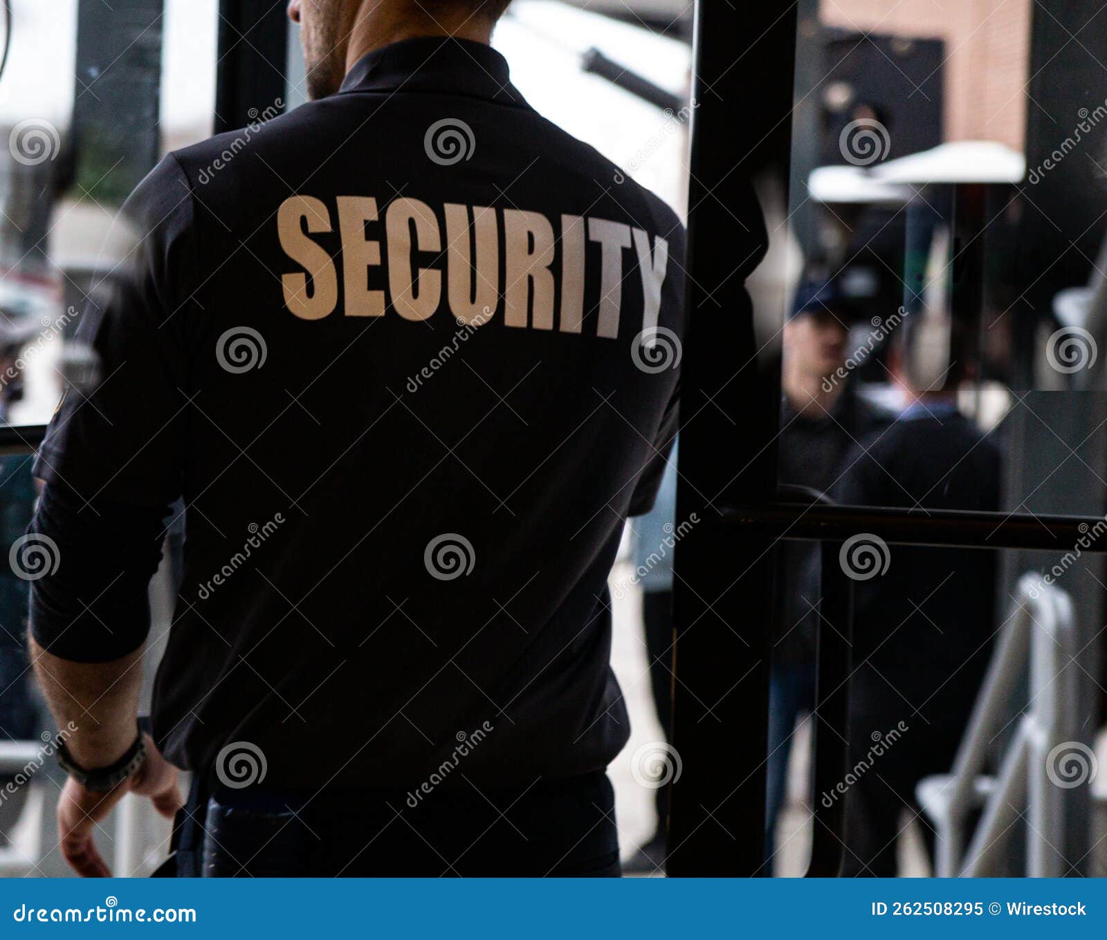 Rear View of a Security Guard in Uniform Patrolling in a Commercial ...