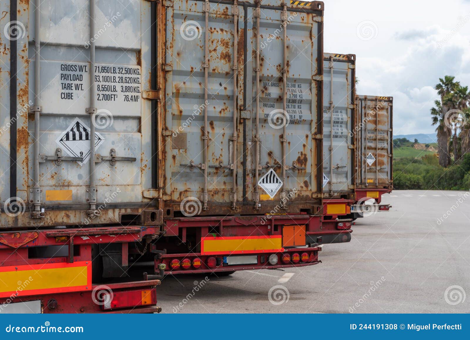 Rear View of Several Trucks with Containers Labeled with Dangerous ...