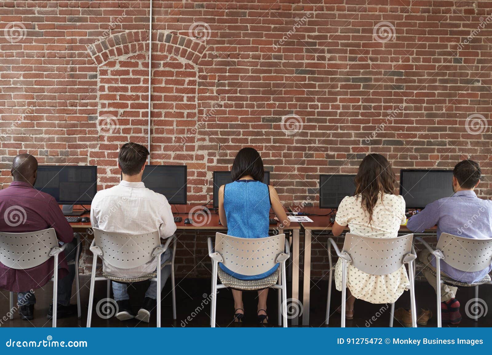 Rear View of Staff at Desks Using Computers in Busy Office Stock Photo ...