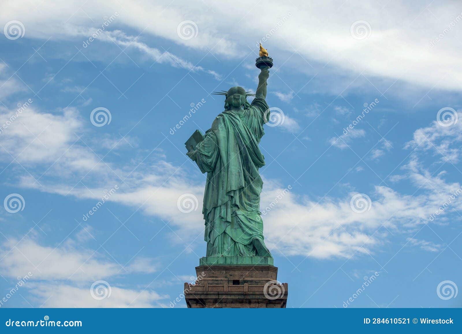 Rear View of the Statue of Liberty Standing Against a Bright, Blue Sky ...