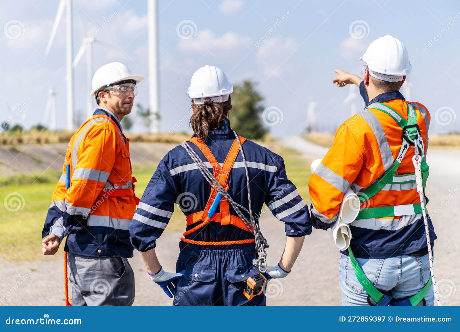 Rear View of Three Caucasian Engineers in Uniform and Hardhat Talk ...