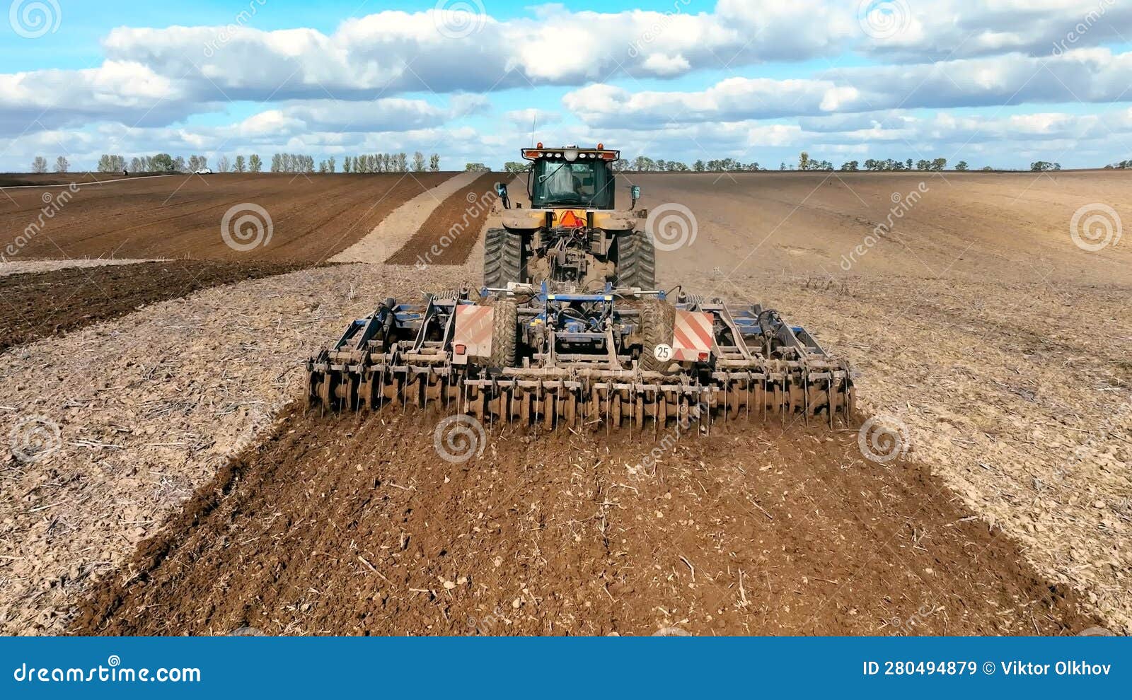 Rear View of a Tractor Plowing a Field with a Plow. Processing of ...