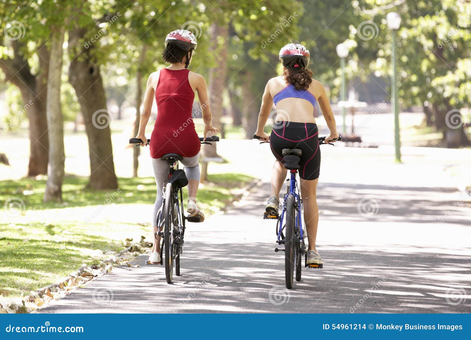 Rear View of Two Women Cycling through Park Stock Photo - Image of ...