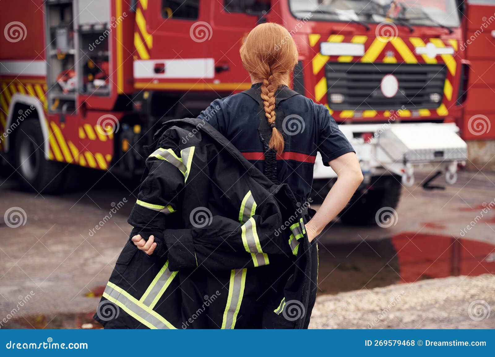 Rear View. Woman Firefighter in Uniform is at Work in Department Stock ...