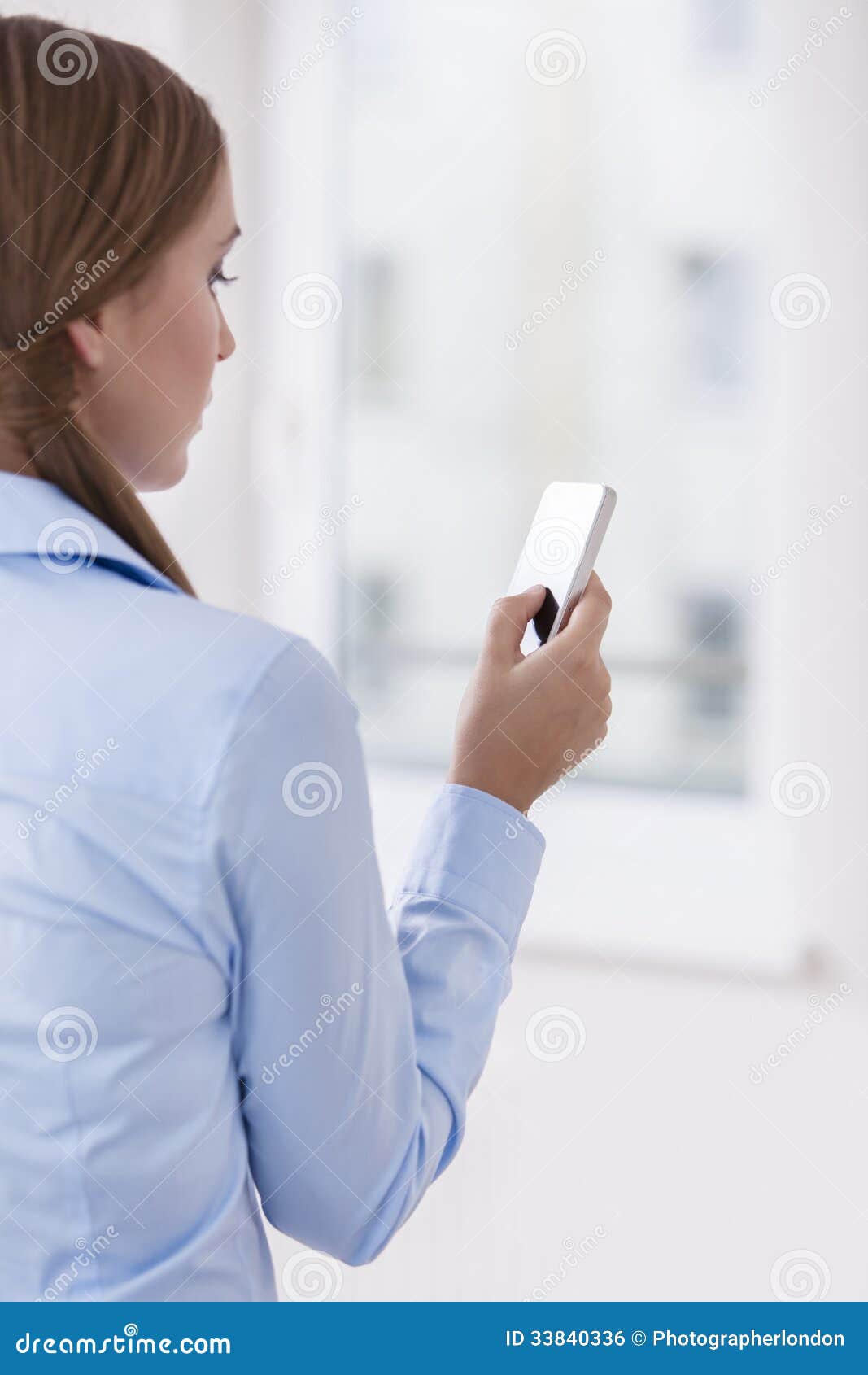 Rear View of a Woman Holding a Smart Phone Stock Photo - Image of ...