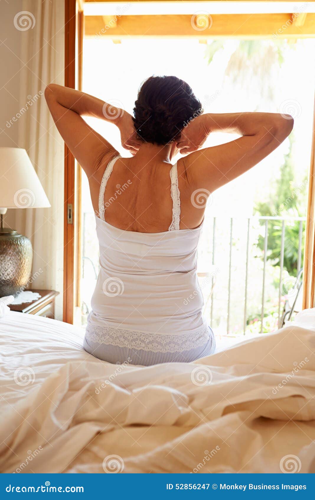 Rear View of Woman Waking Up in Bed in Morning Stock Image - Image of ...
