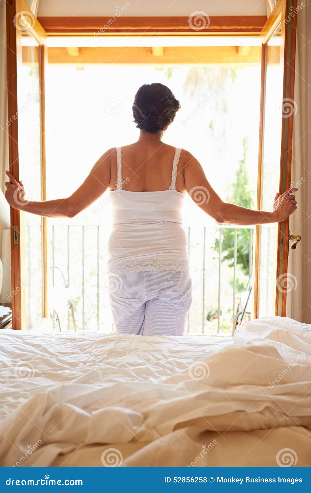 Rear View of Woman Waking Up in Bed in Morning Stock Photo - Image of ...