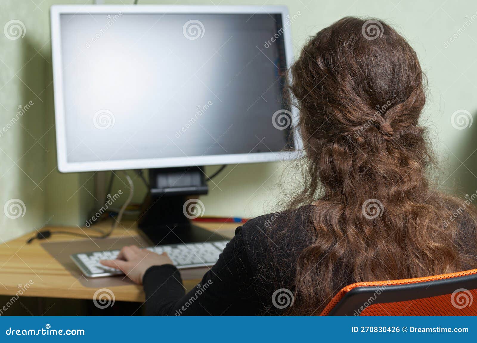Rear View of a Woman Working at a Desktop Computer Stock Photo - Image ...