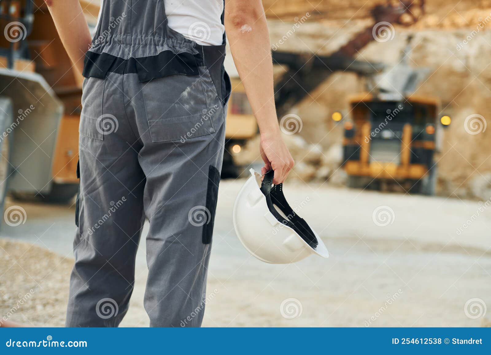 Rear View. Worker in Professional Uniform is on the Borrow Pit at ...