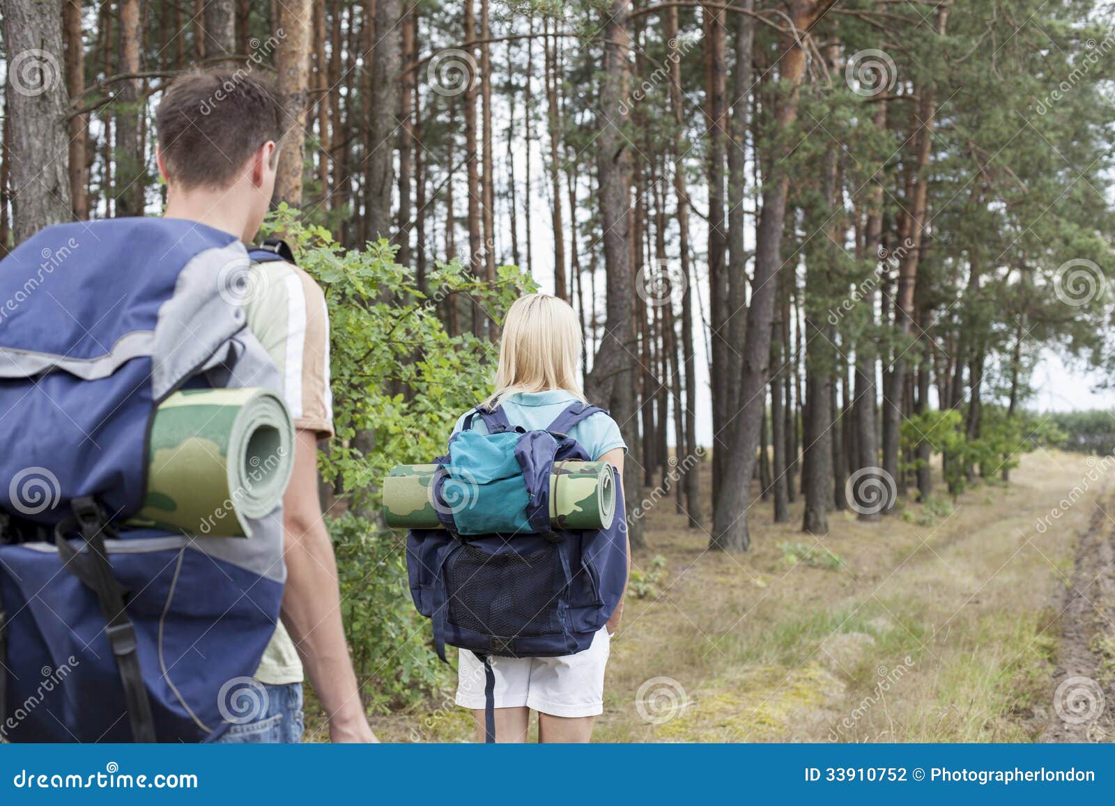Rear View of Young Backpackers Walking in Forest Trail Stock Photo ...