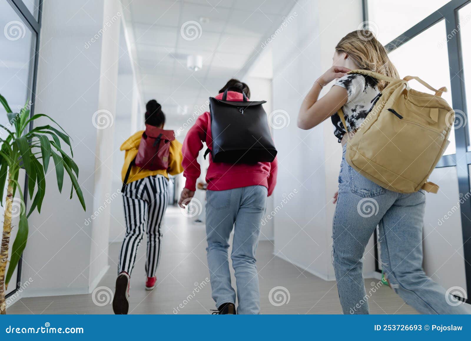 Rear View of Young High School Students Walking in Corridor at School ...
