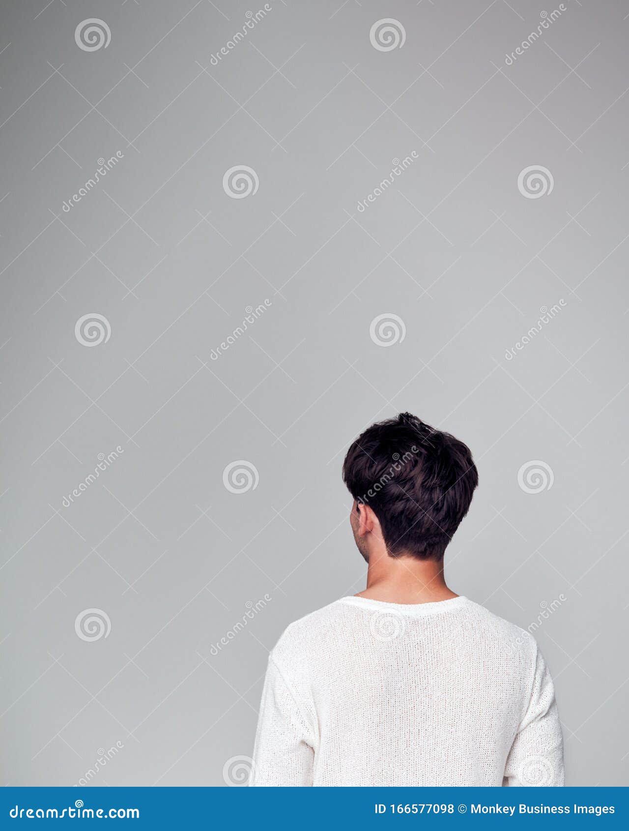 Rear View of Young Man Looking Away from Camera in Studio Stock Photo ...