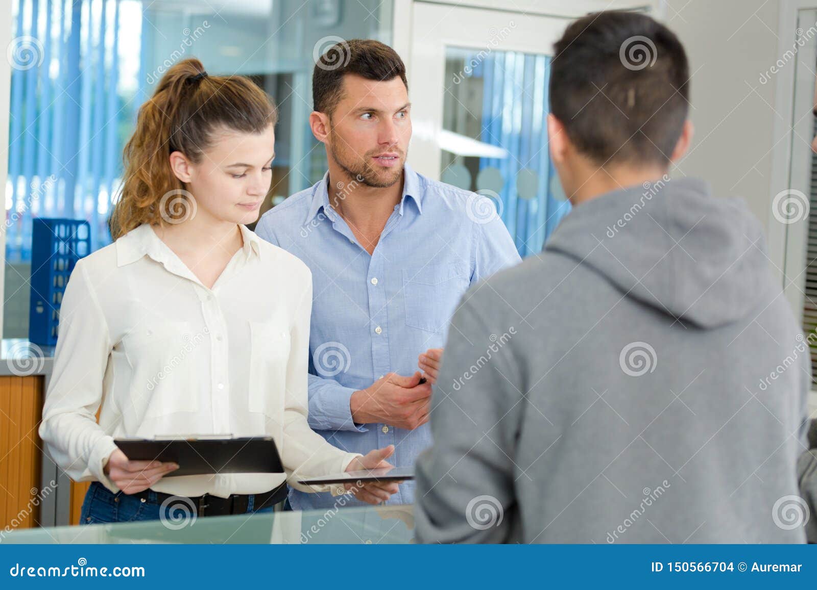Rear View Young Man at Reception Desk Stock Photo - Image of ...