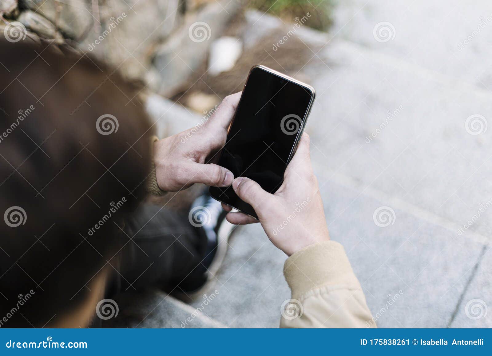 Rear View of Young Man Using Mobile Phone while Sitting Outdoors Stock ...
