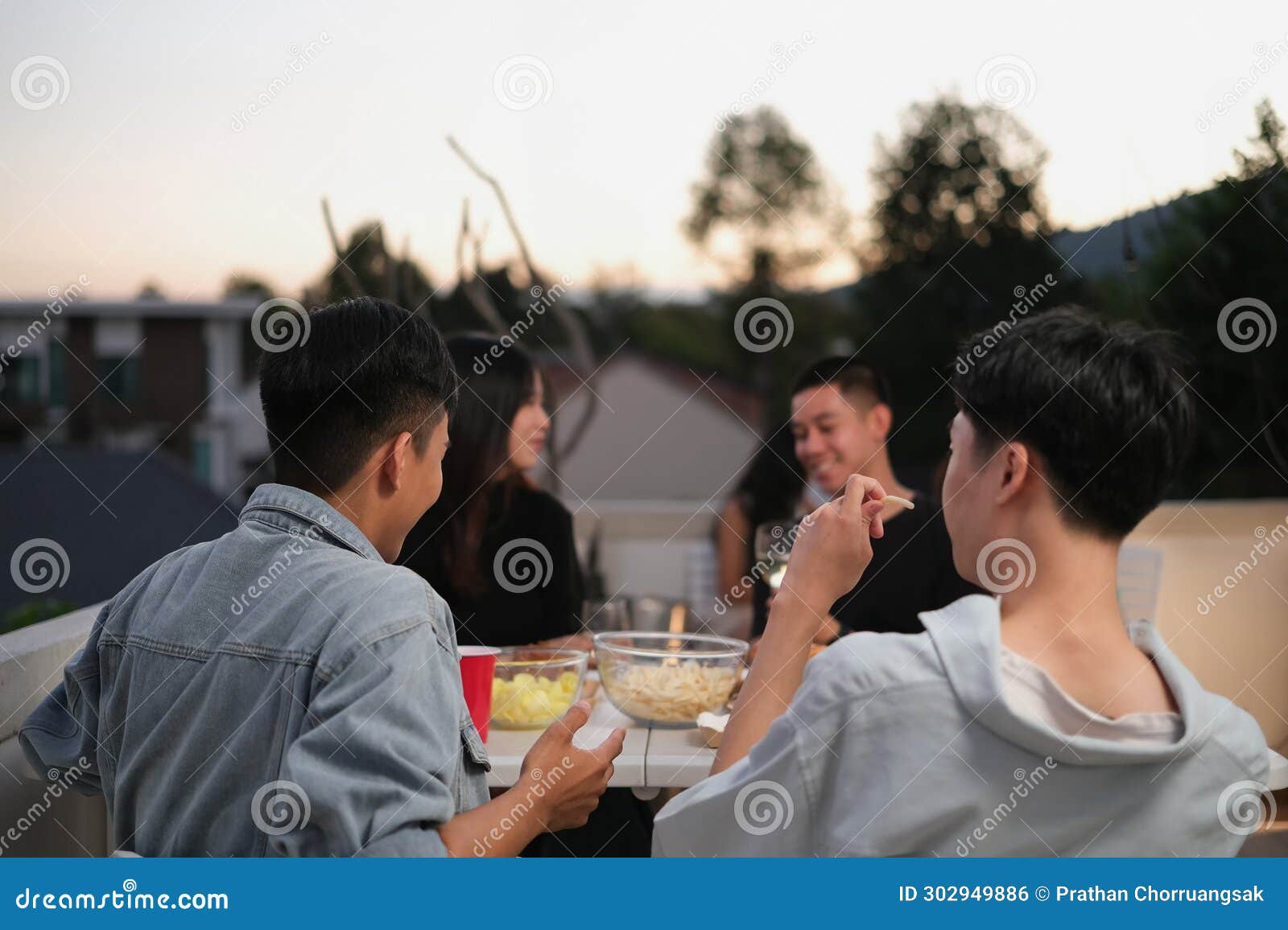 Rear View of Young People Enjoying Conversation at Rooftop Party in ...