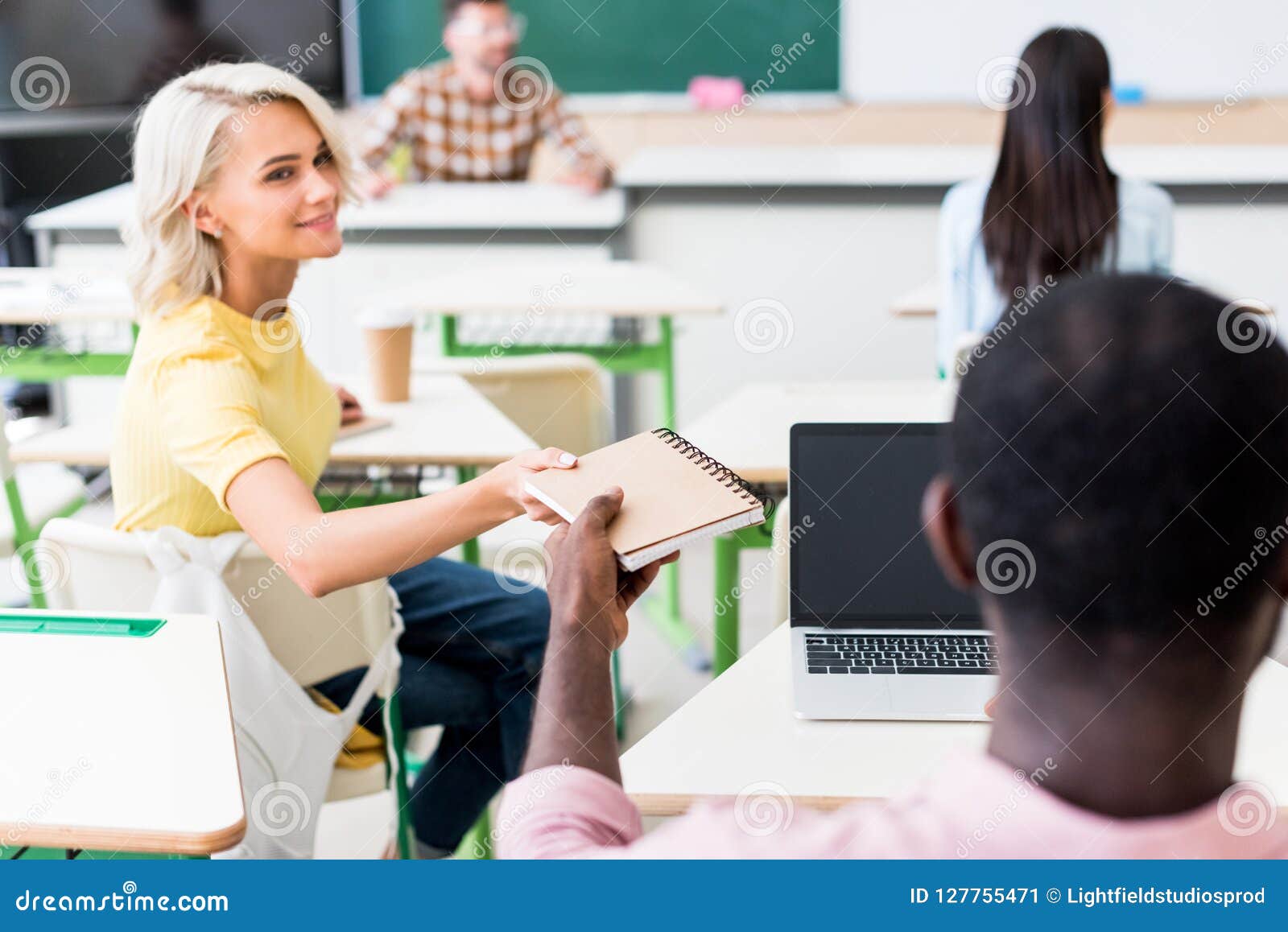 Rear View of Young Students Sharing Notebook at Classroom Stock Image ...