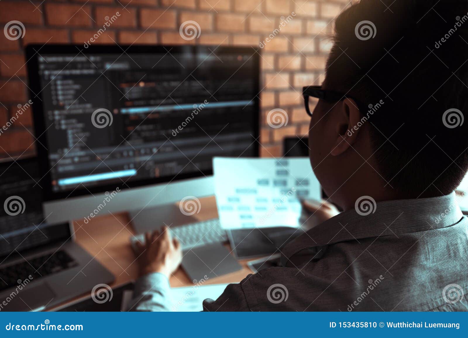 Rearview Of The Software Developer Is Working On A Computer Keyboard