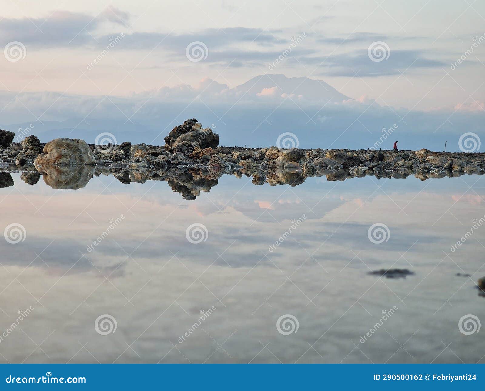 Receding Sea Water with Views of Mountains Behind the Clouds Stock ...