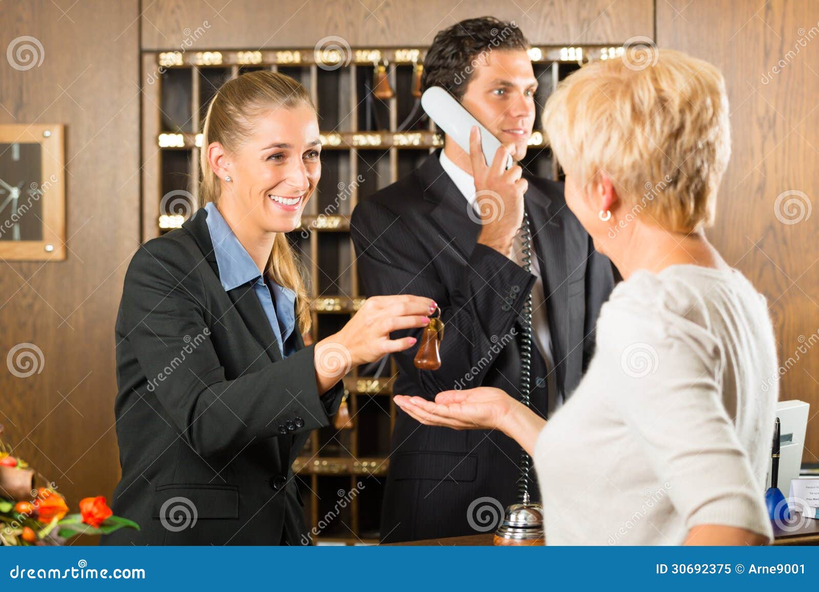 Reception - Guest Checking in a Hotel Stock Image - Image of cabinet ...