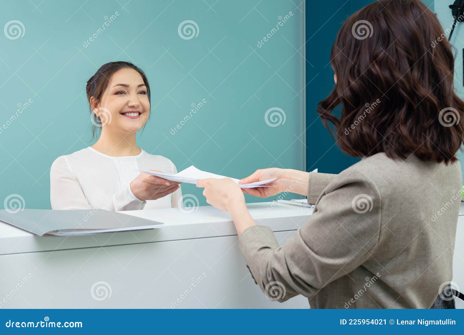 Receptionist Accepts Documents from the Female Visitor Stock Image ...