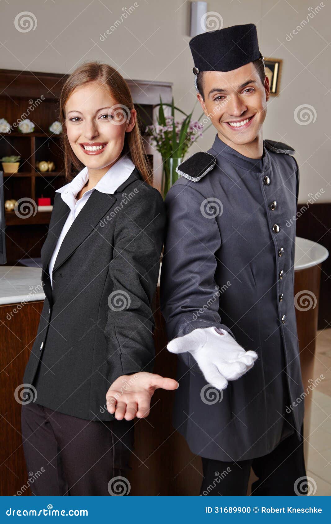 Receptionist and Bellboy in Hotel Offering Welcome Stock Photo - Image ...