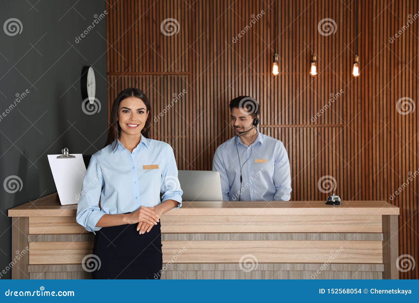 Receptionist at Desk with Colleague Stock Photo - Image of office ...