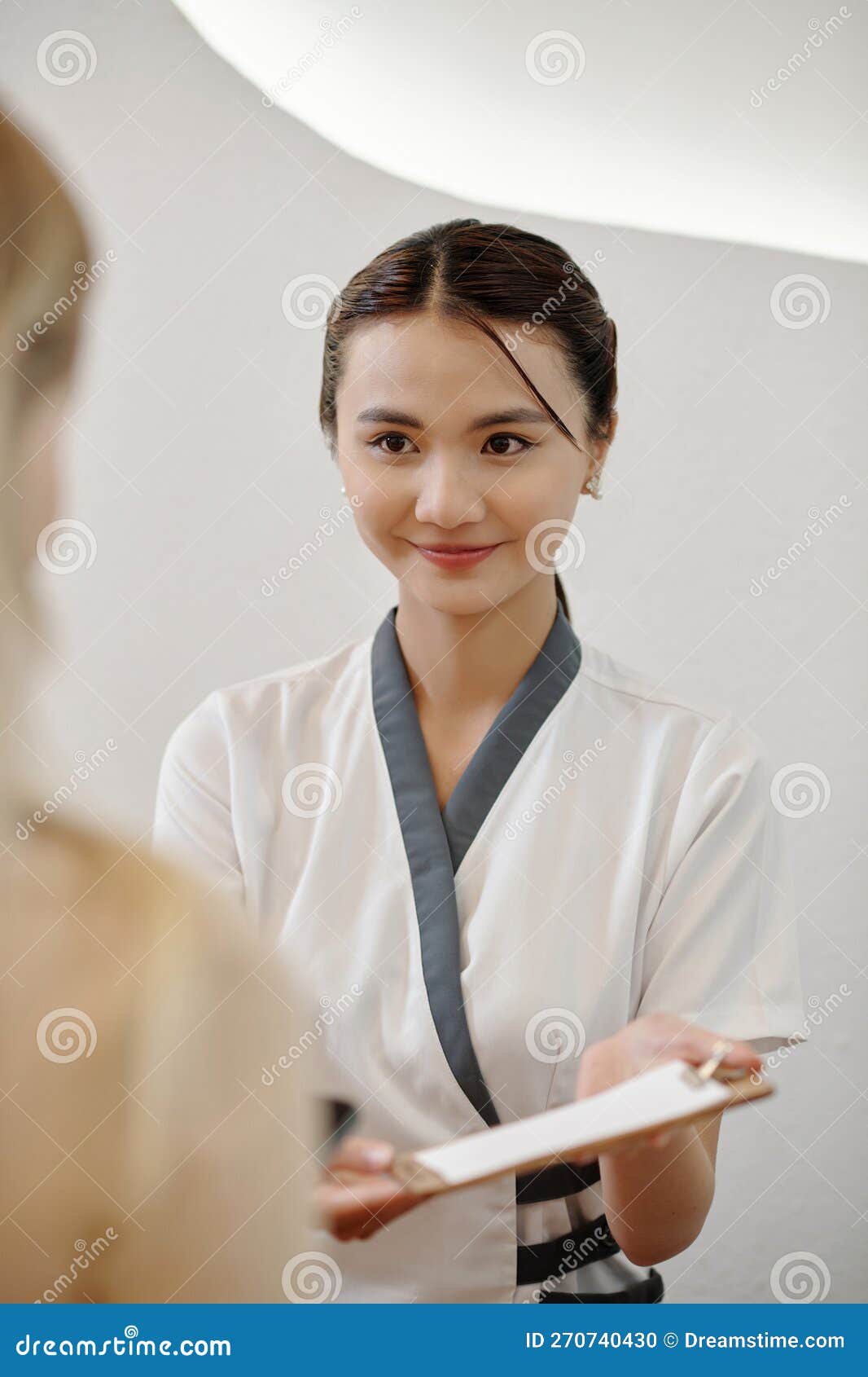 Receptionist Giving Form To Client Stock Photo - Image of resort ...