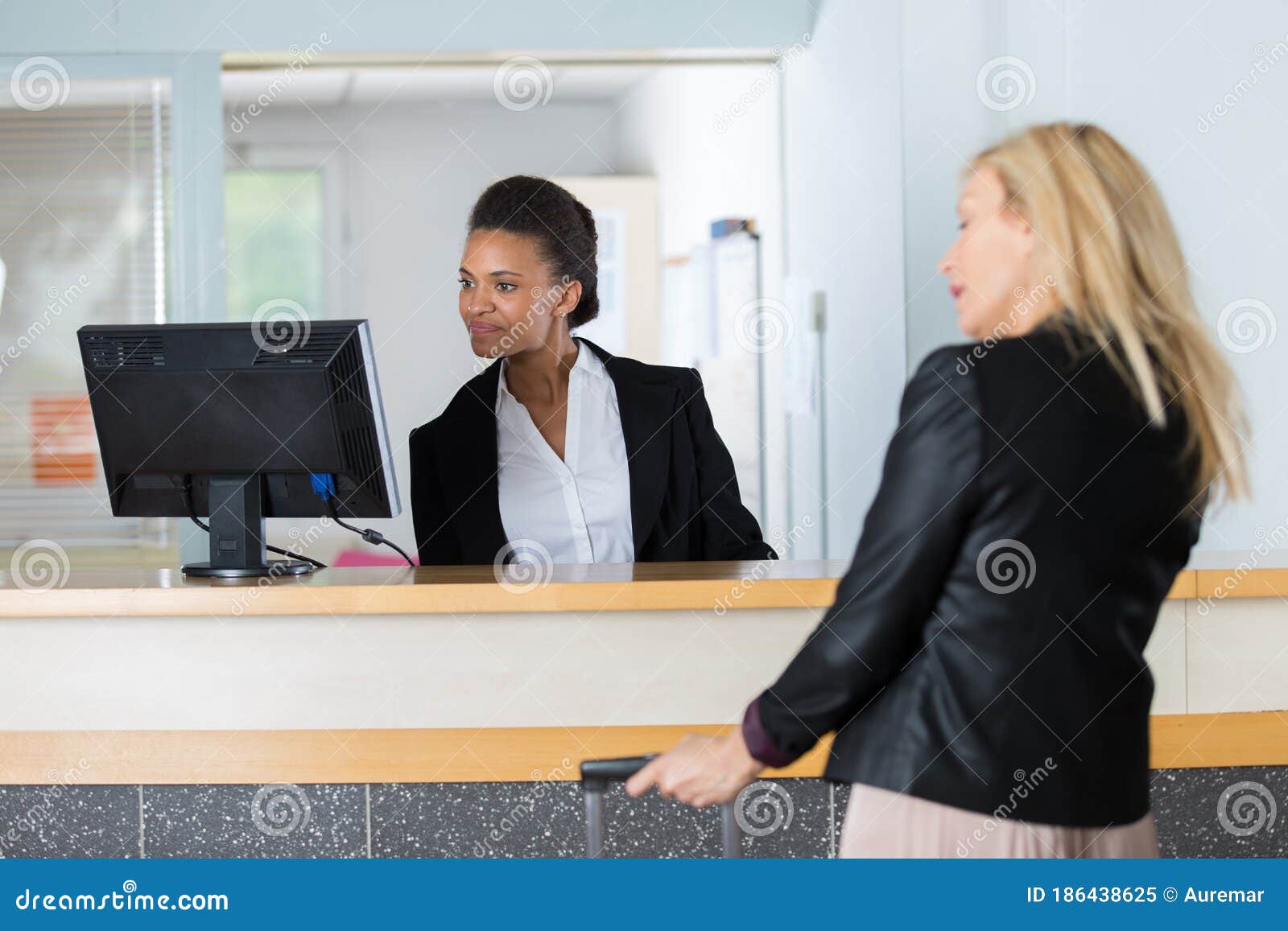Receptionist Helping Hotel Guest Check in Stock Image - Image of desk ...