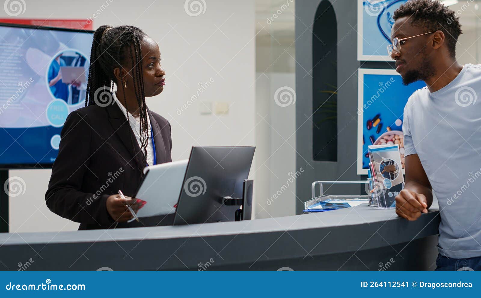 Receptionist Helping Patients with Checkup Forms Stock Image - Image of ...