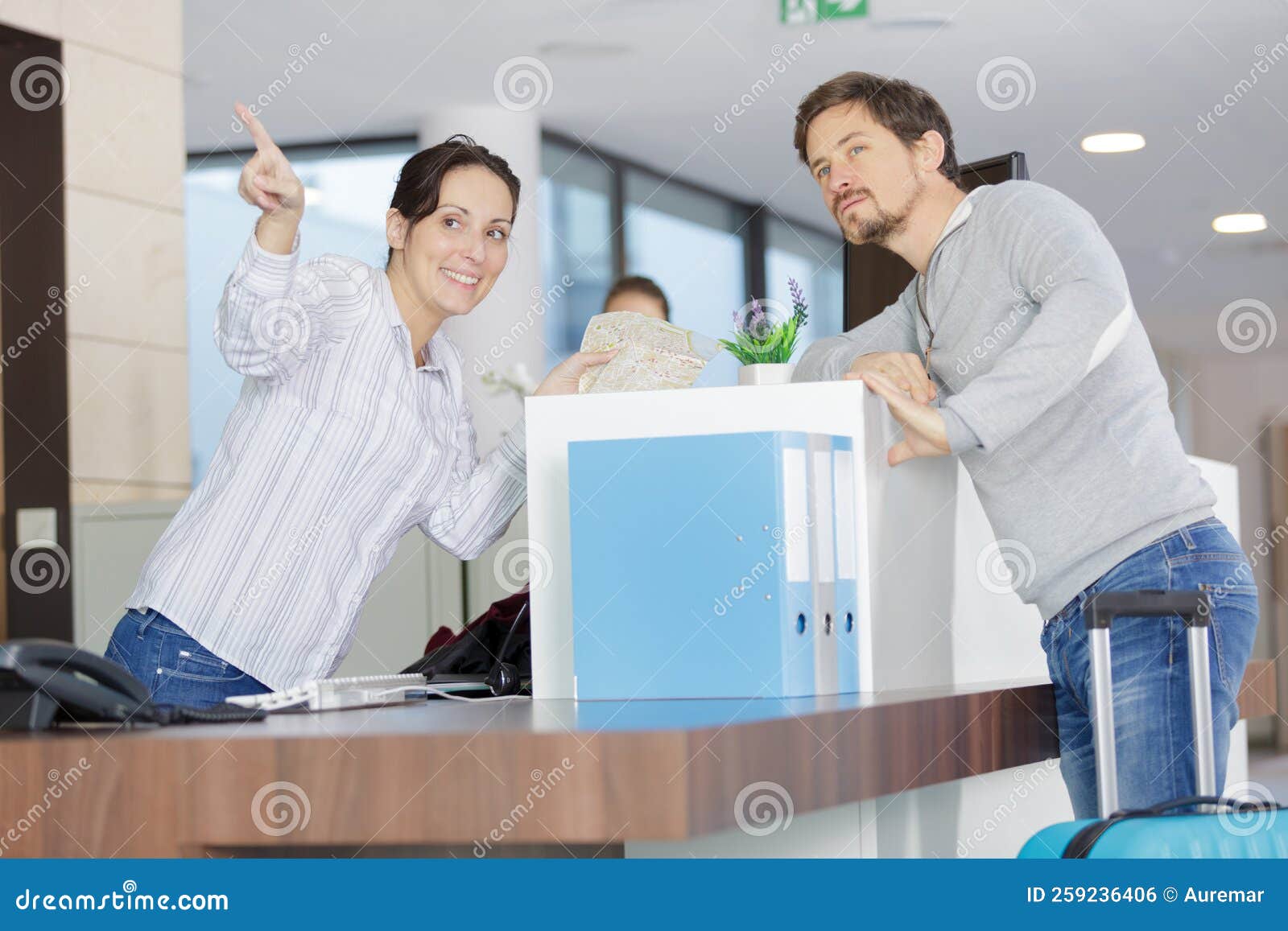 Receptionist Pointing Client in Right Direction Stock Photo - Image of ...
