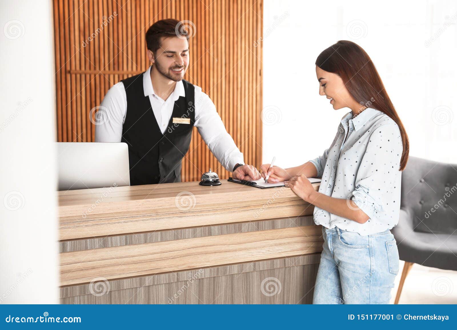 Receptionist Registering Client at Desk Stock Image - Image of ...