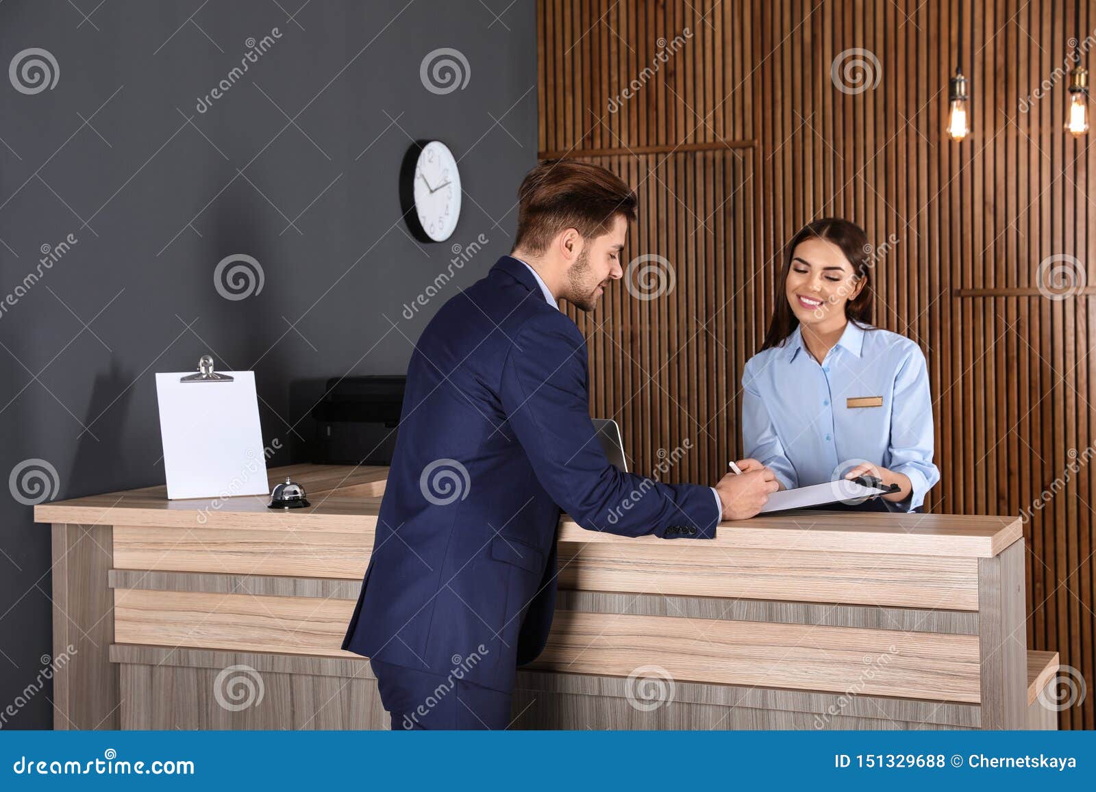 Receptionist Registering Client at Desk Stock Photo - Image of booking ...
