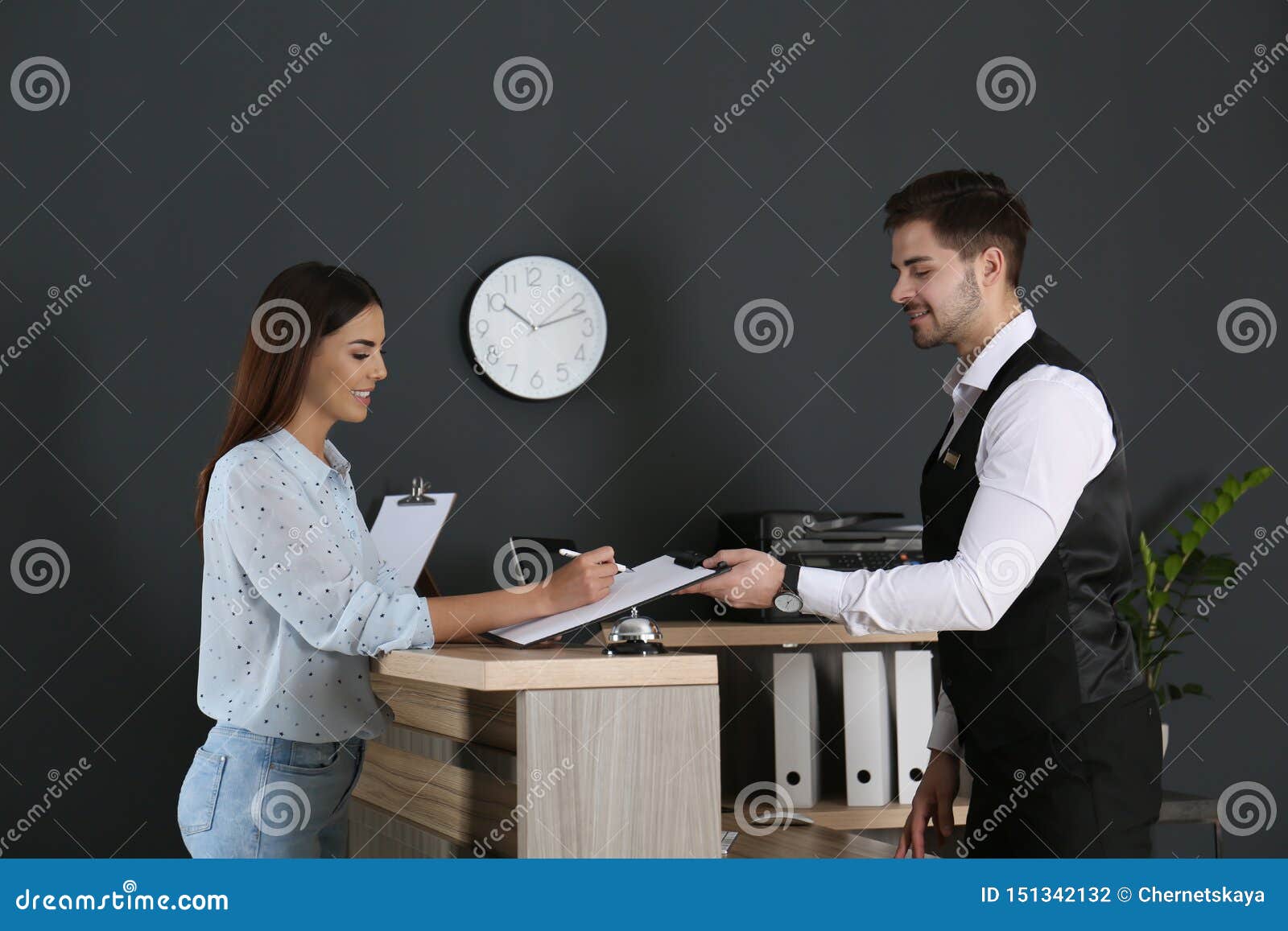 Receptionist Registering Client at Desk Stock Photo - Image of indoors ...