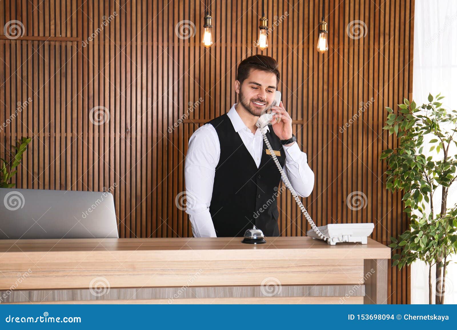 Receptionist Talking on Phone at Desk Stock Photo - Image of ...