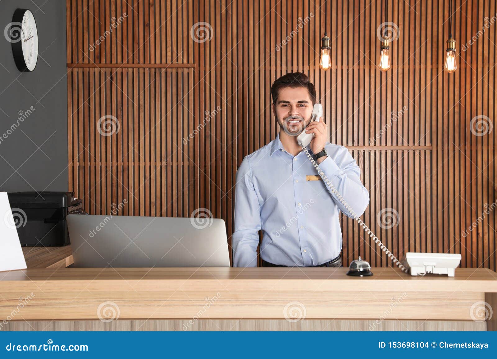 Receptionist Talking on Phone at Desk Stock Photo - Image of room ...