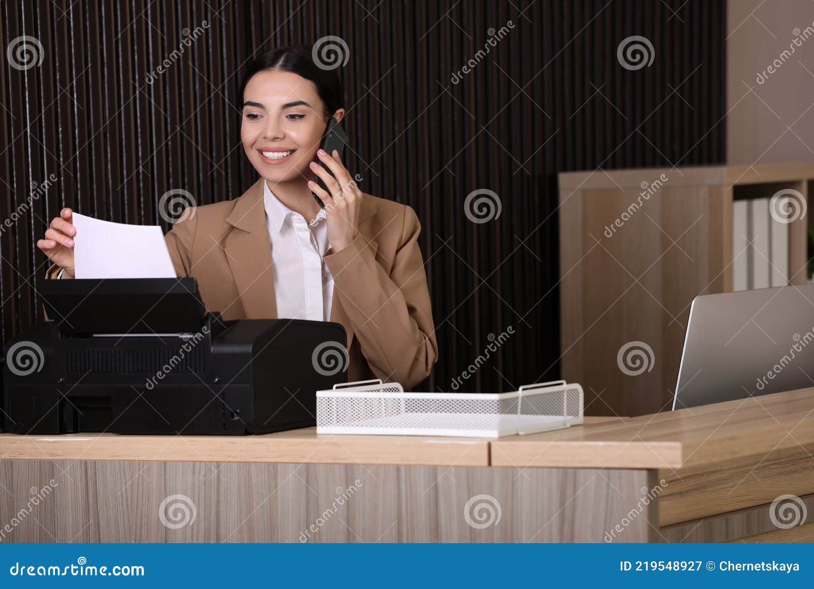 Receptionist Talking on Smartphone at Countertop in Office Stock Image ...