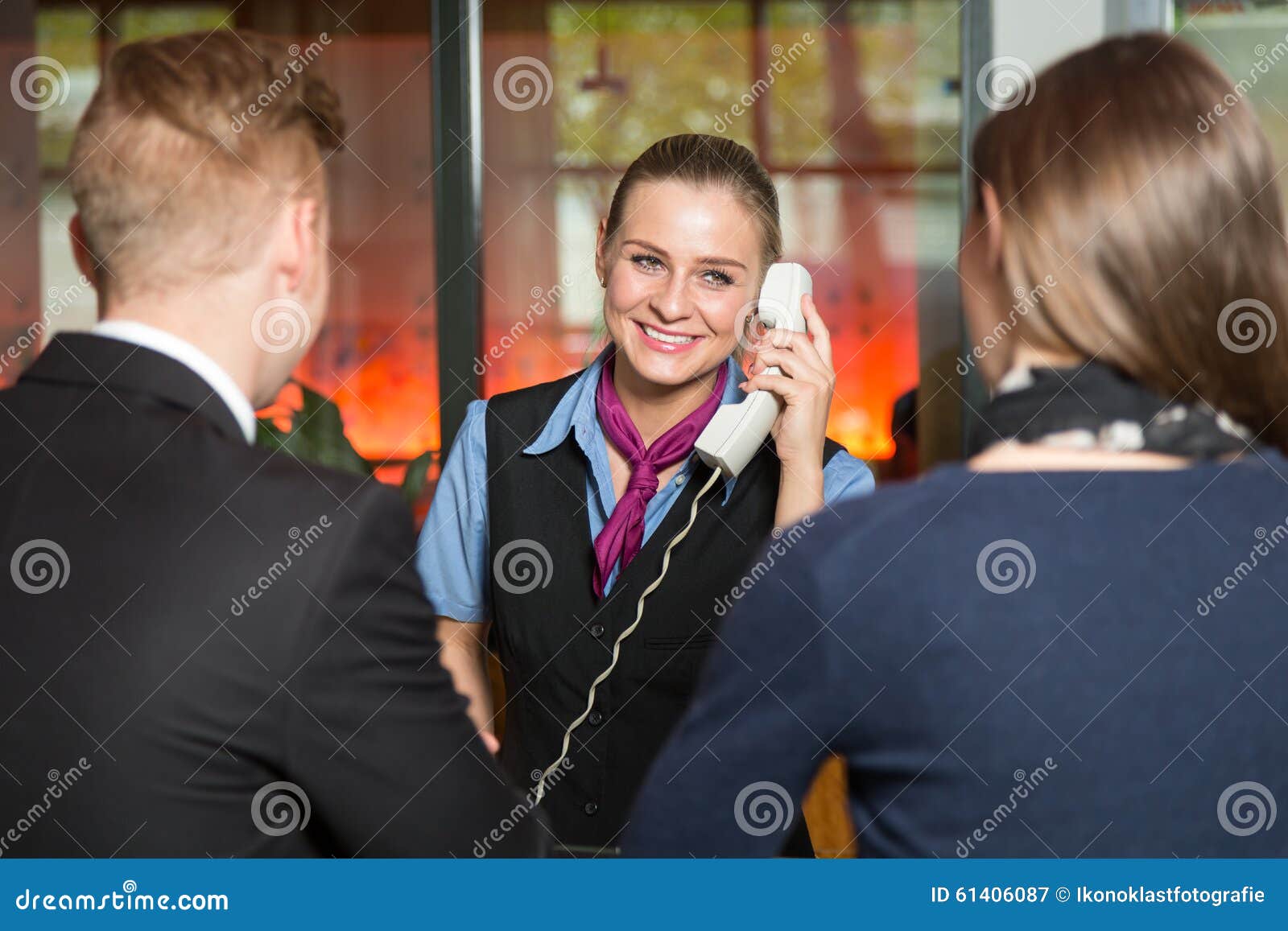 Receptionist with Telephone Assisting Guests in Hotel Stock Image ...