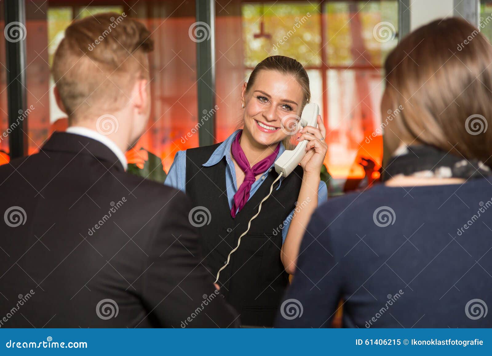 Receptionist with Telephone Assisting Guests in Hotel Stock Image ...