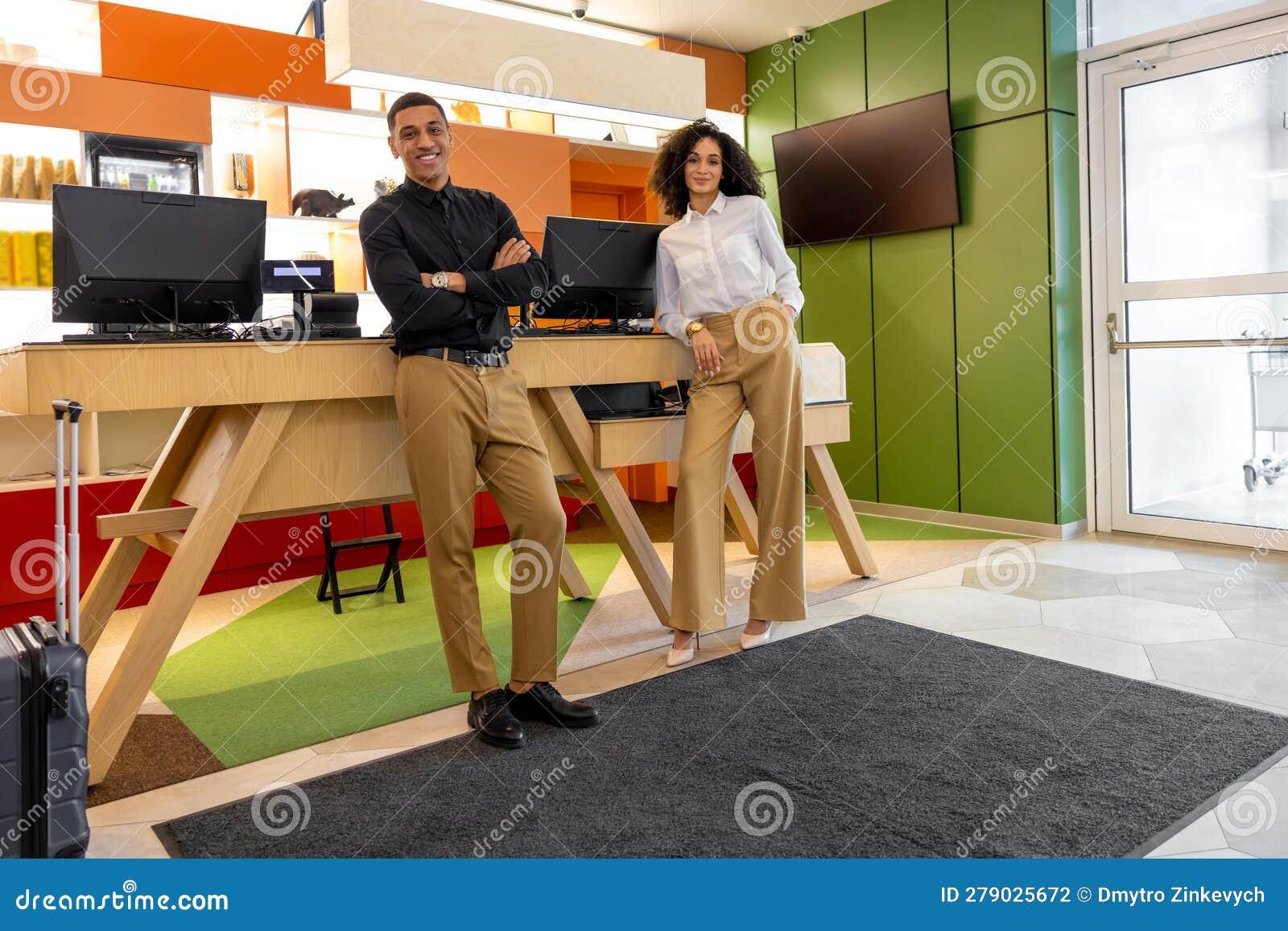Receptionists at the Hotel Reception Desk Looking Happy and Confident ...