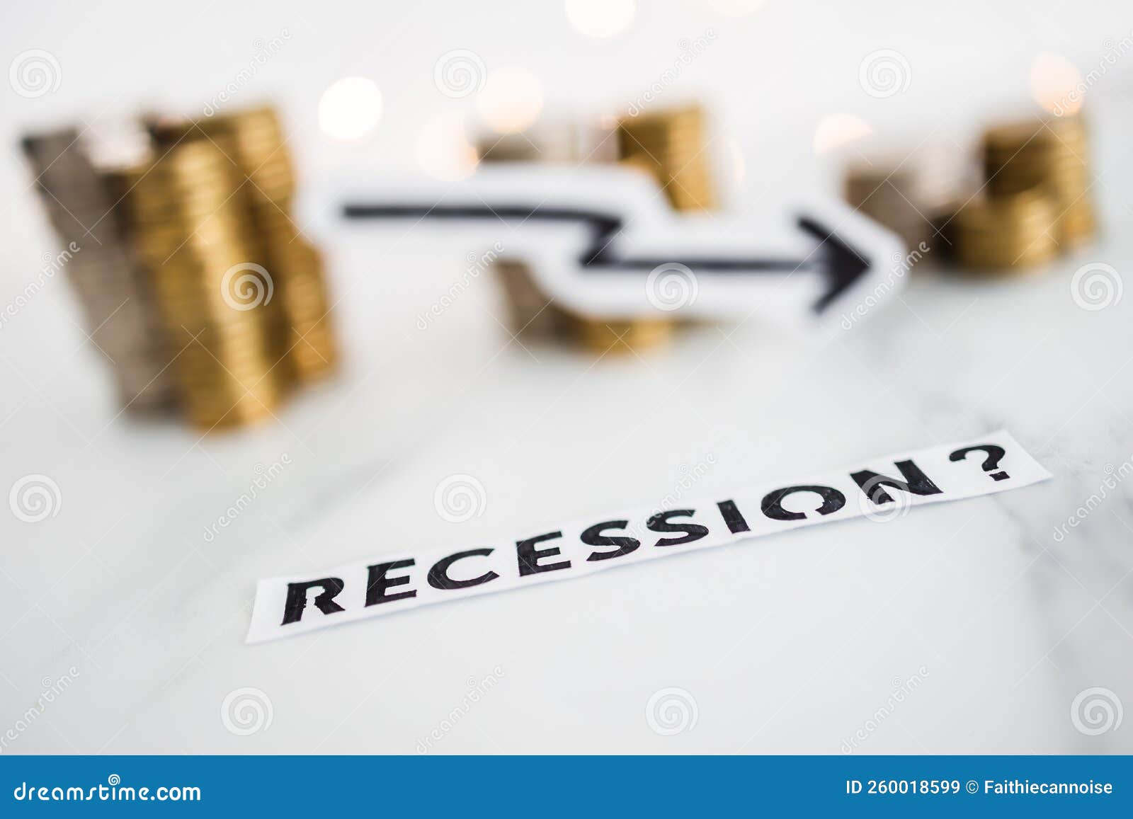Recession Text with Arrow Going Down in Front of Decreasing Stacks of ...
