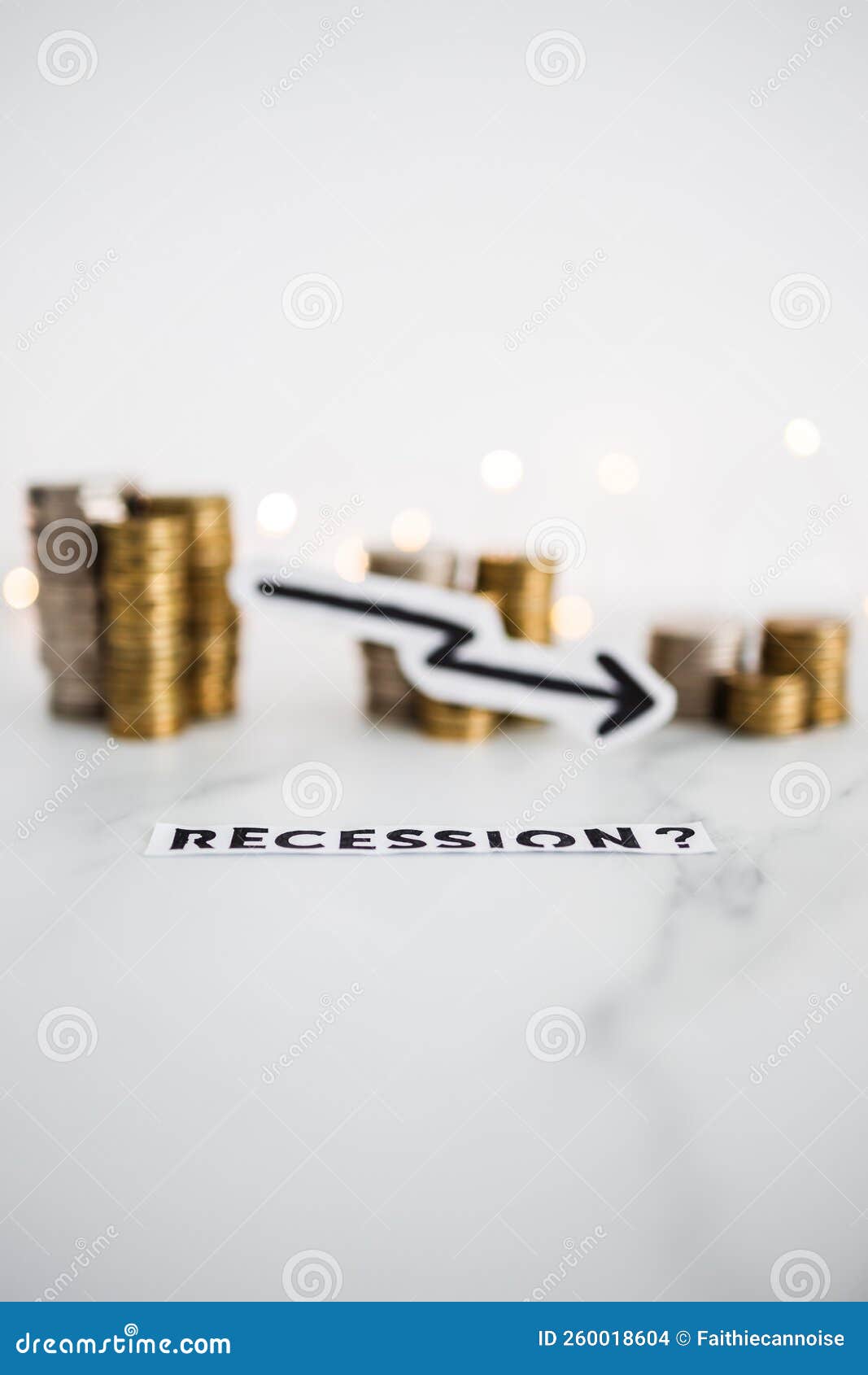 Recession Text with Arrow Going Down in Front of Decreasing Stacks of ...