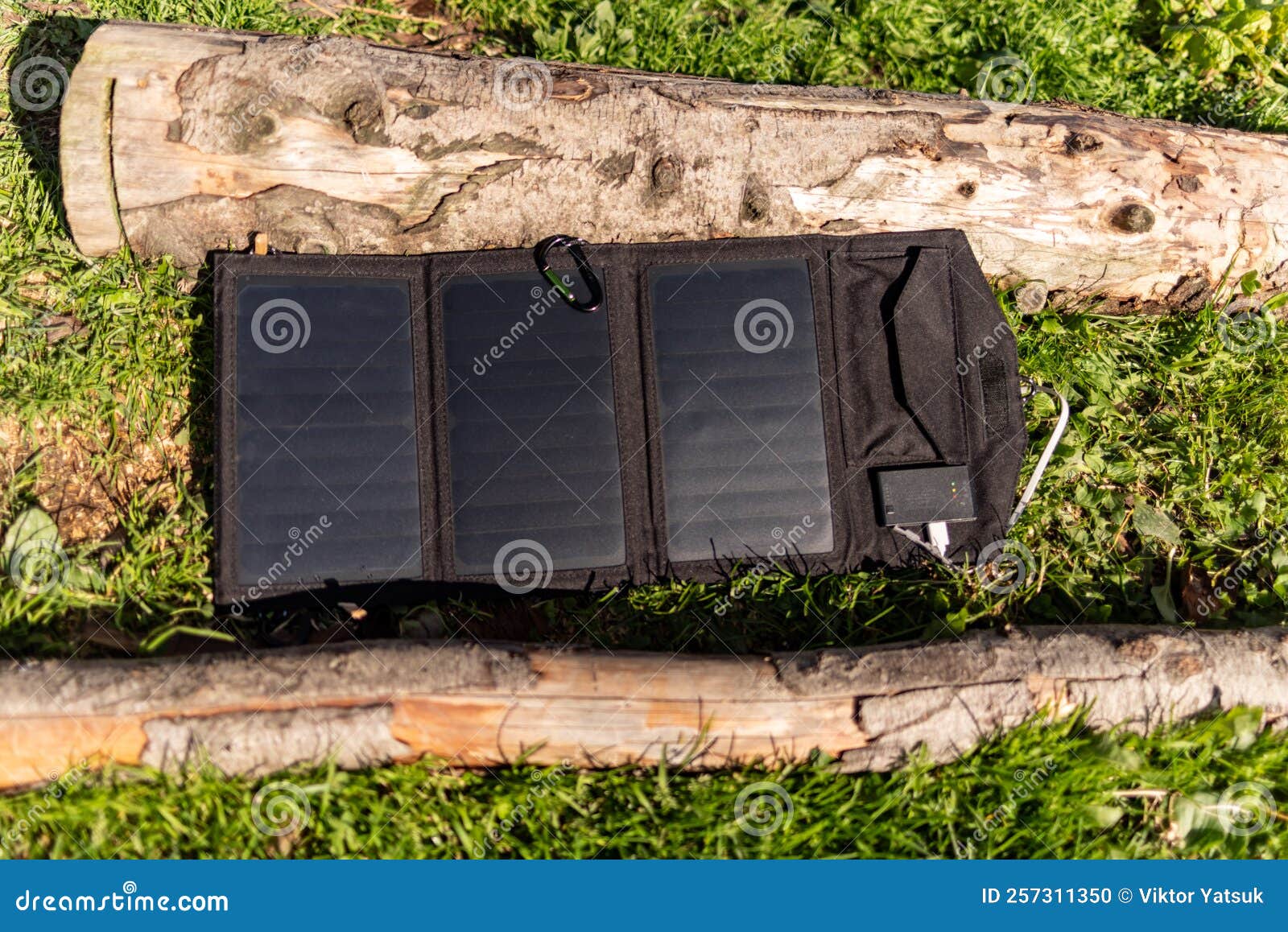 Recharging a Compact Solar Panel. Charging a Tourist Solar Battery on a ...