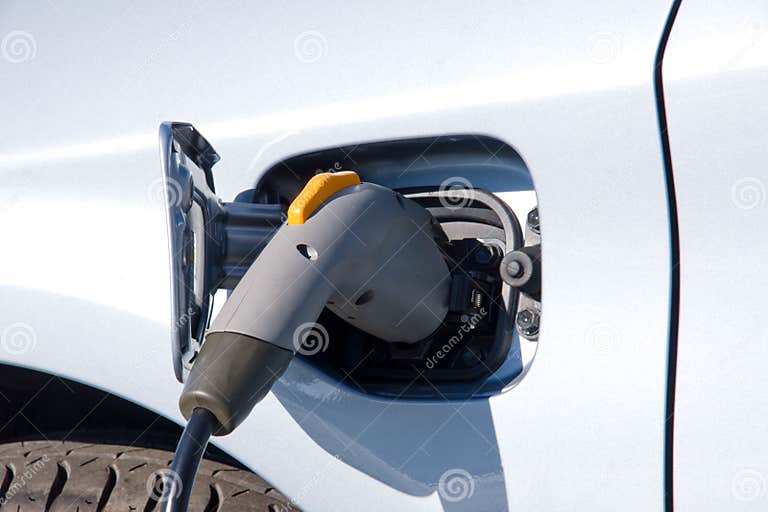 Recharging an electric car stock image. Image of outlet - 17042959
